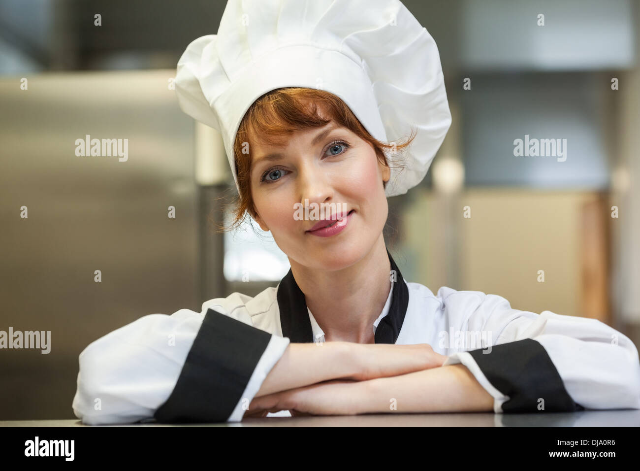Pretty smiling head chef looking at camera Stock Photo - Alamy