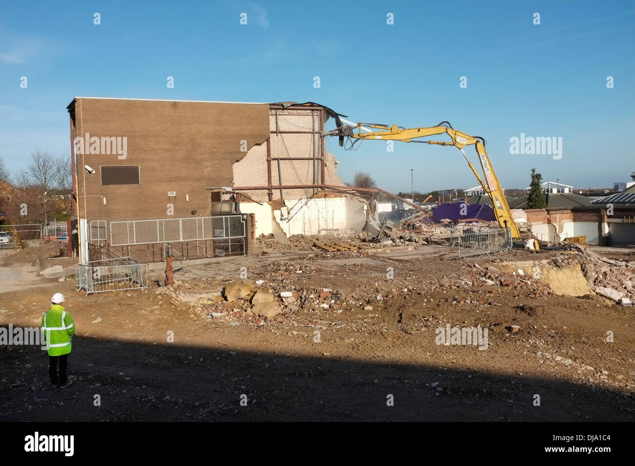 JCB Demolishing an old brick building Stock Photo - Alamy