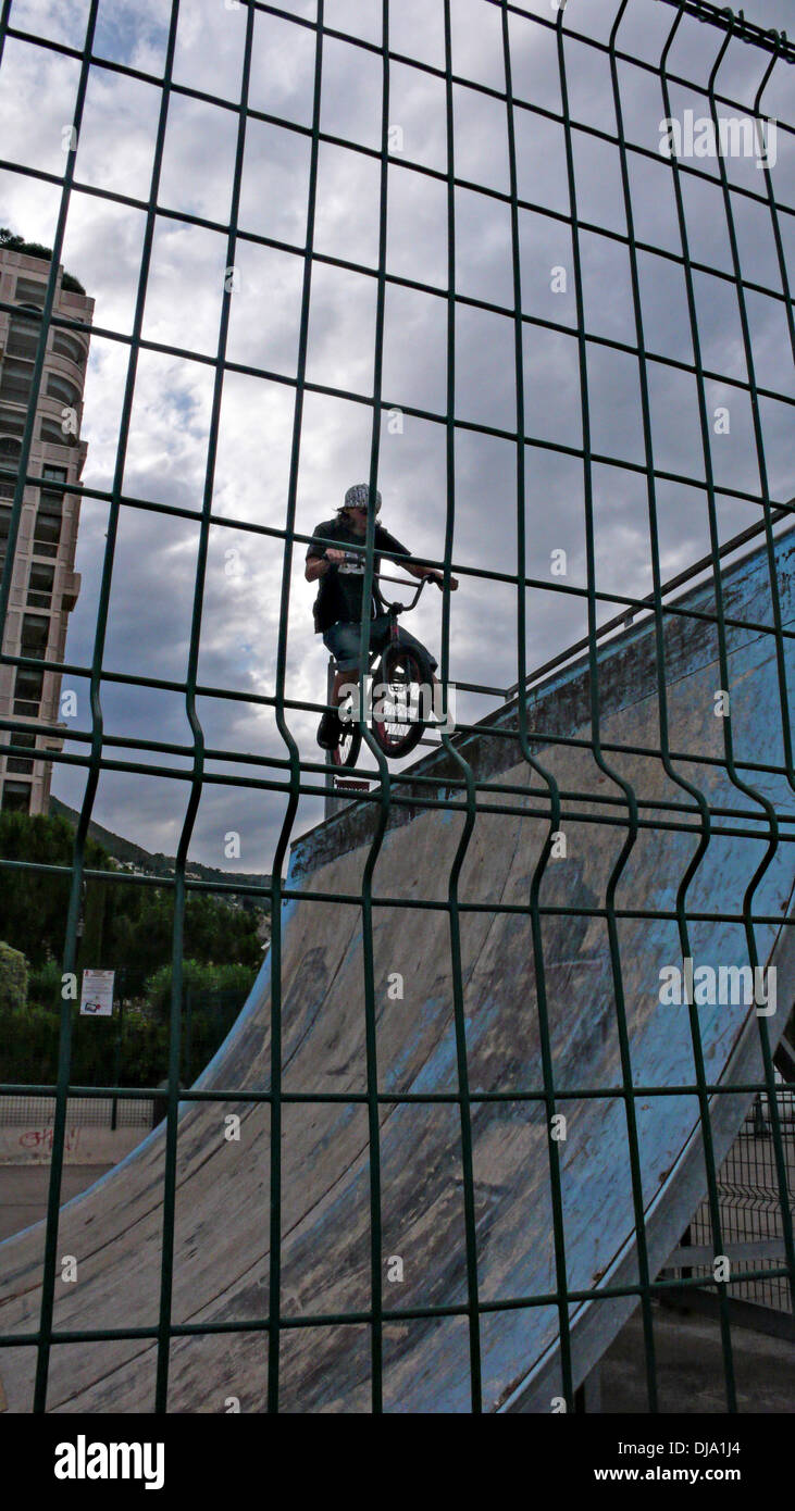 A skateboarder on a ramp with a high rise building behind him Stock ...
