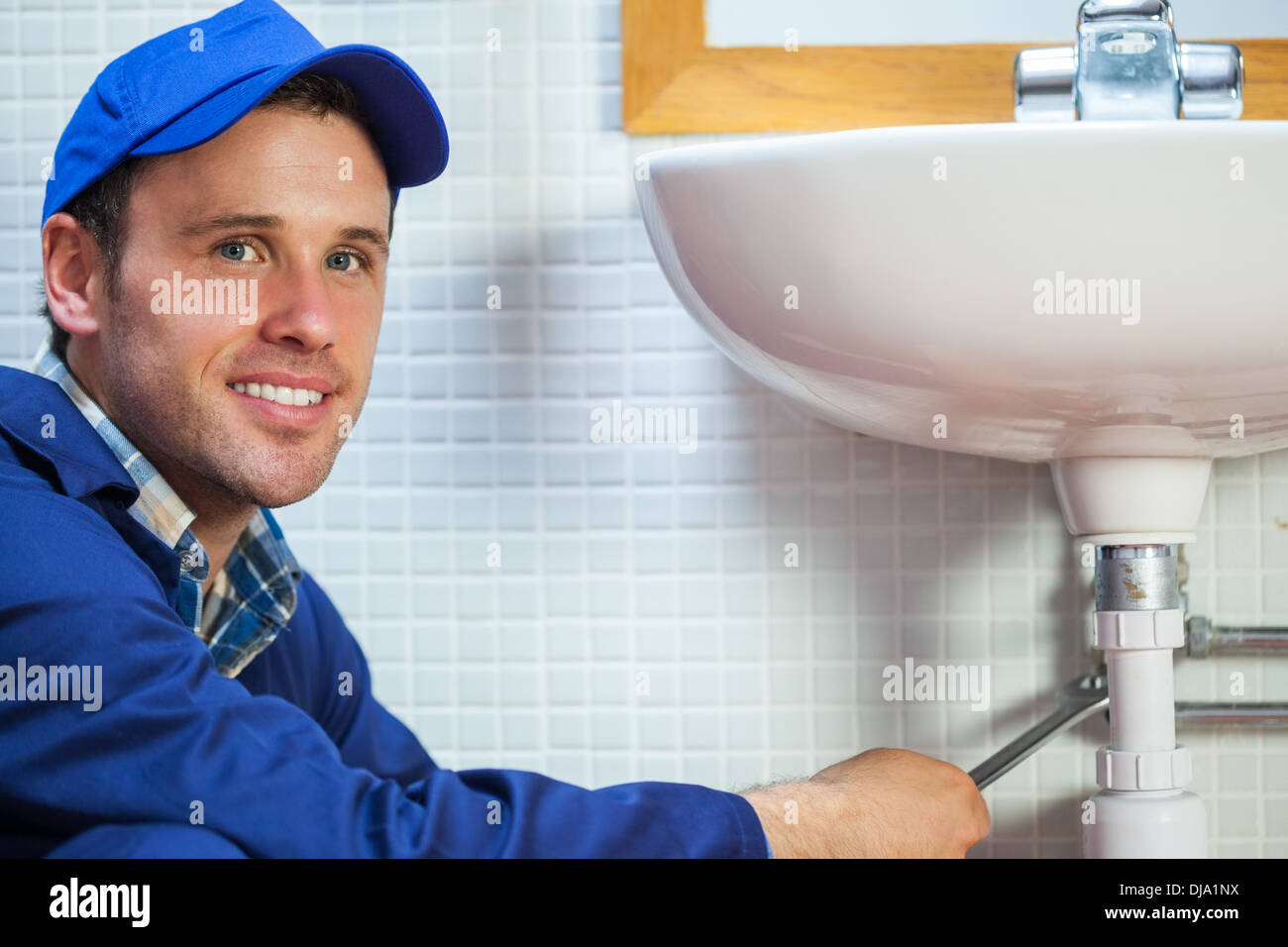 Sitting looking at camera smiling holding pipe hi-res stock photography ...