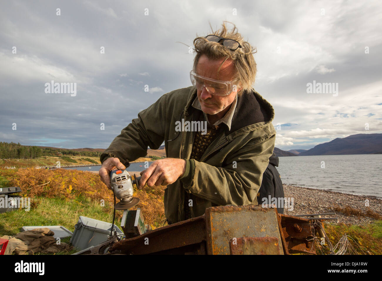 Hugh Piggott doing maintenance on his home made wind turbines in ...