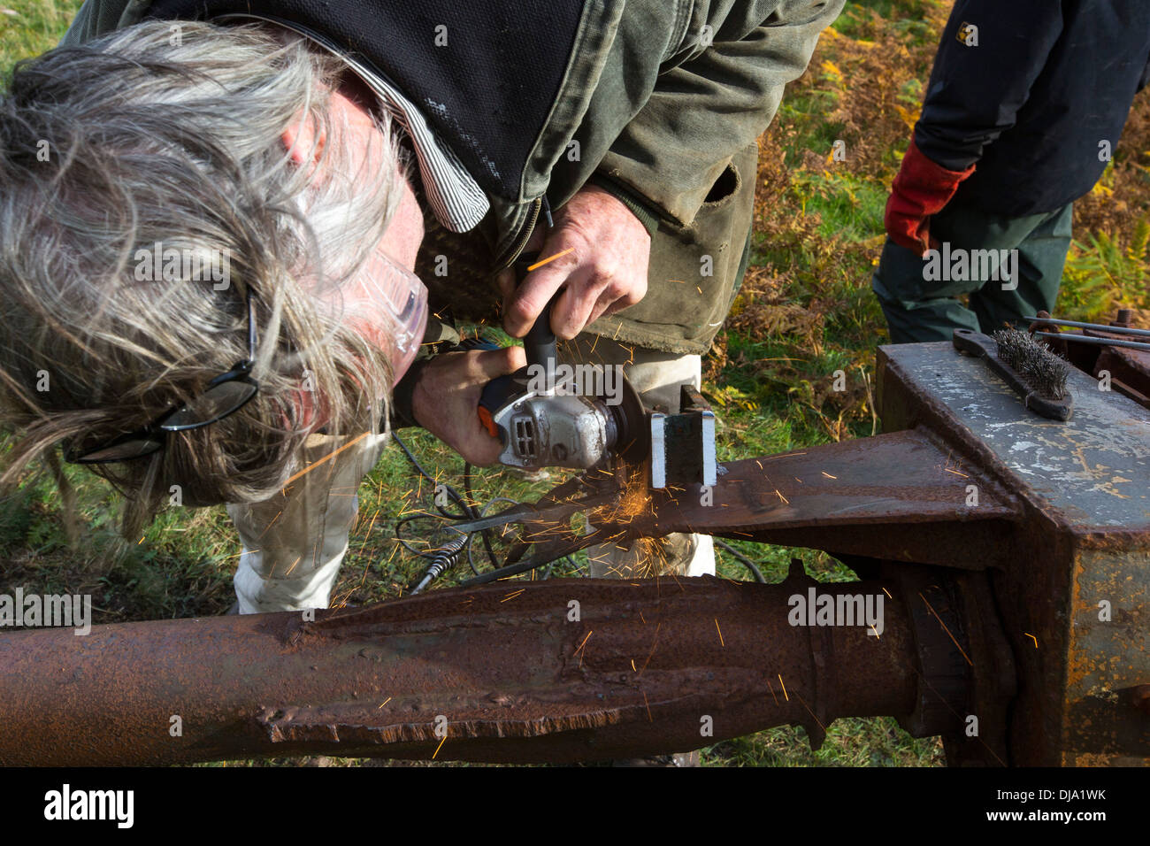 Hugh Piggott doing maintenance on his home made wind turbines in ...