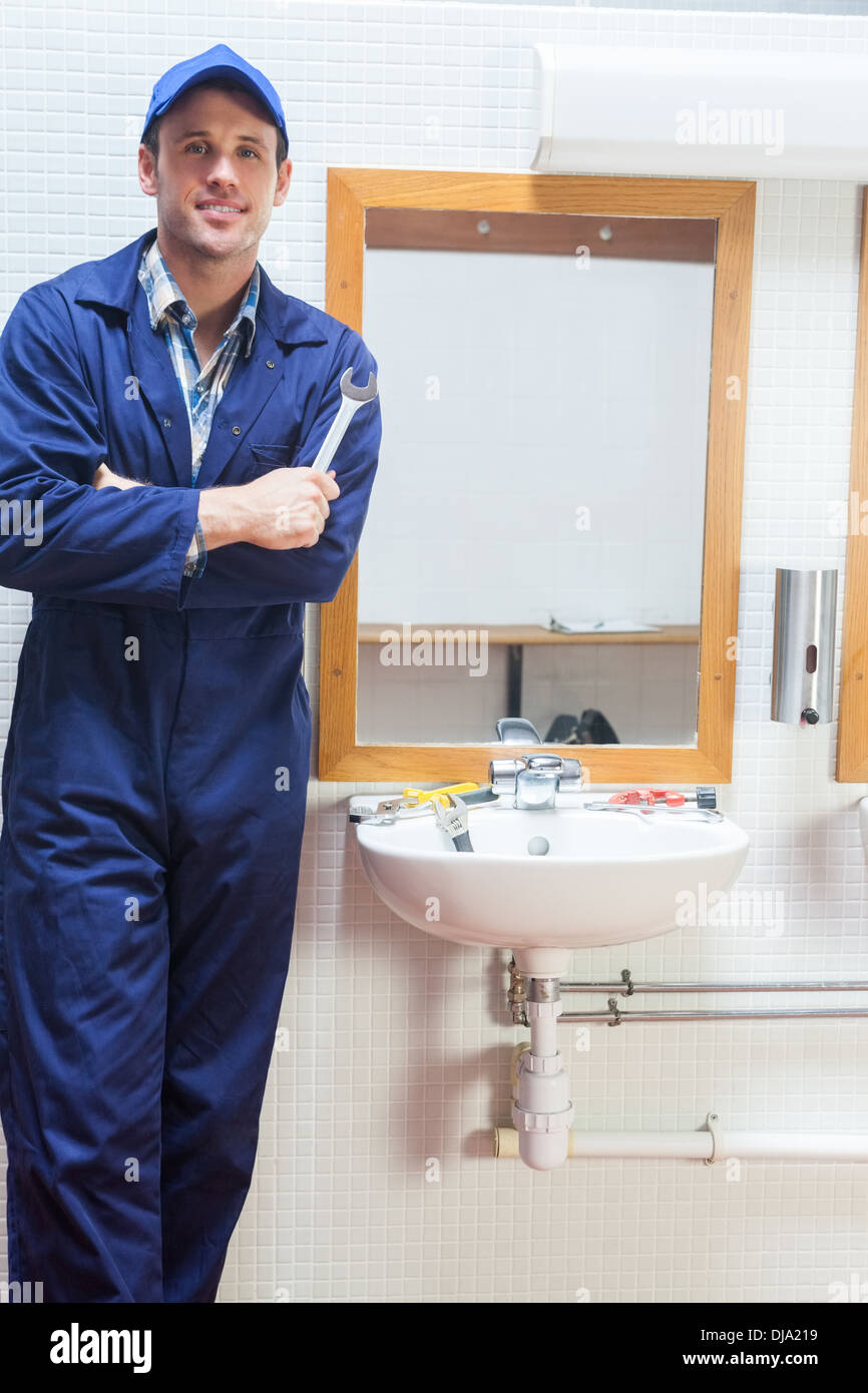 Happy plumber posing with wrench Stock Photo - Alamy