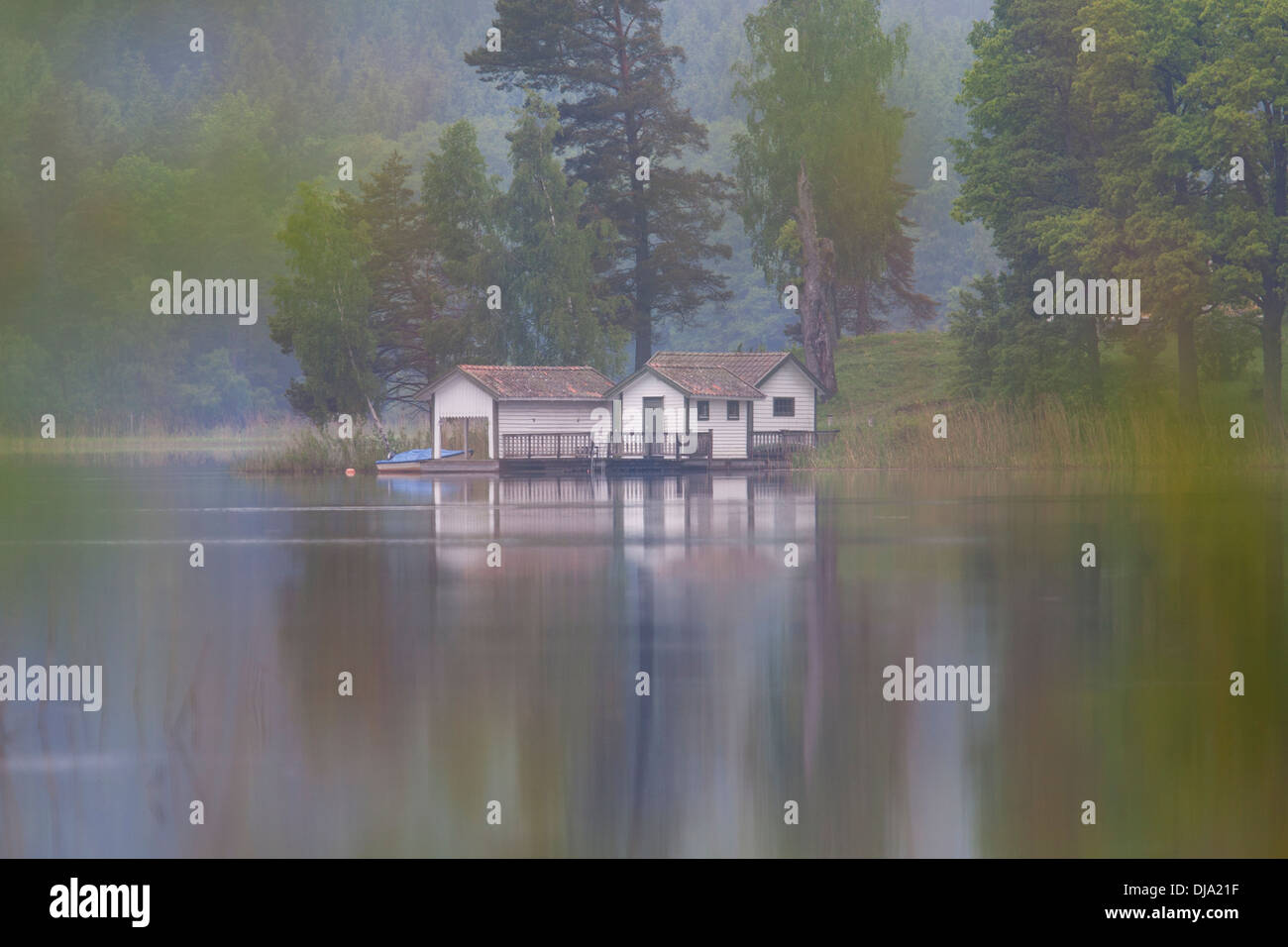 View of two beautiful cottages built on a lake Stock Photo - Alamy