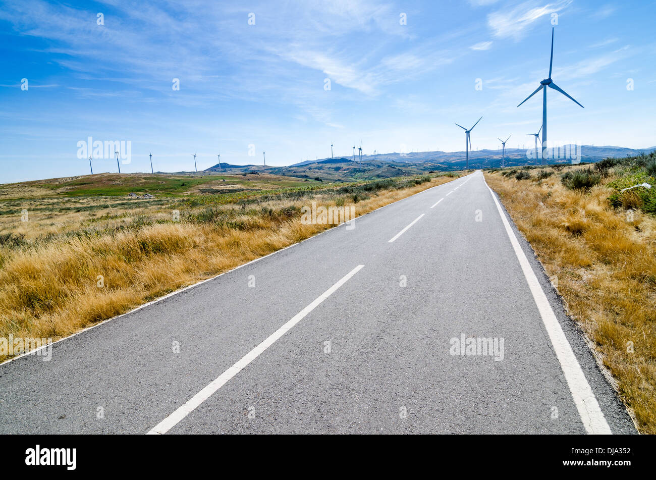 Asphalt road through a wind turbines mountain field Stock Photo - Alamy