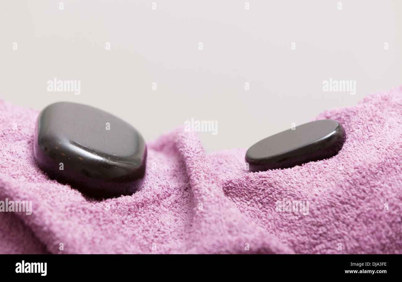 Spa relax body care concept. Zen, hot massage stone pebbles on pink ...