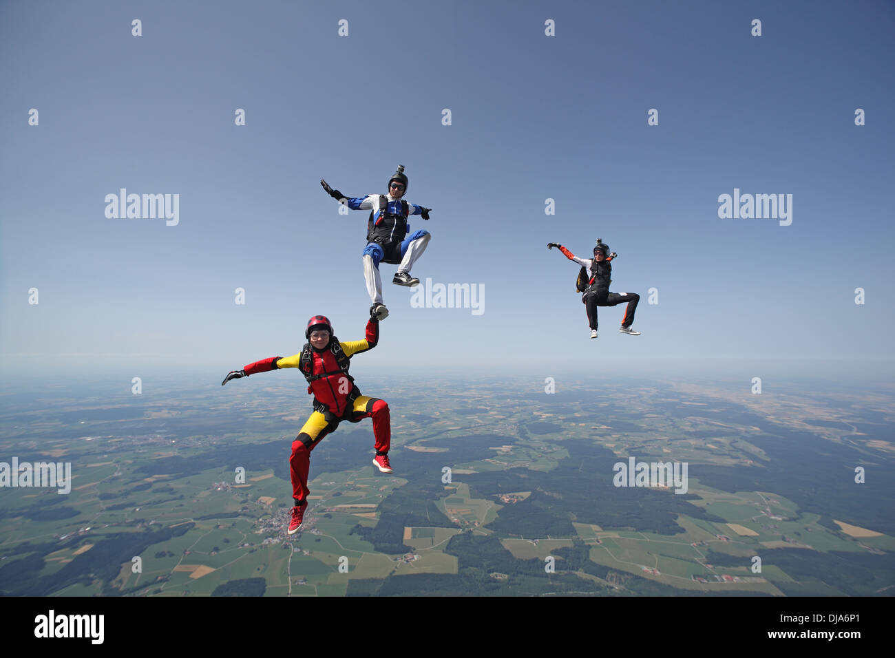 Freefly skydiving team is training formation back/sit-flying over a ...