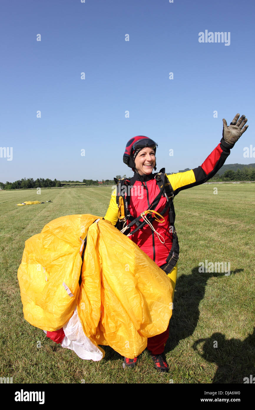 This skydiver girl landed with her parachute and is now very happy to ...