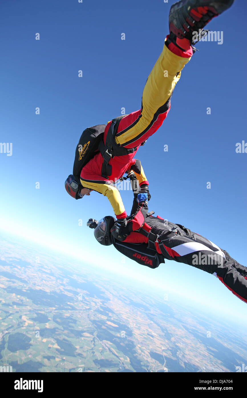 Skydivers are jumping out of an airplane and holding hand for a big ...