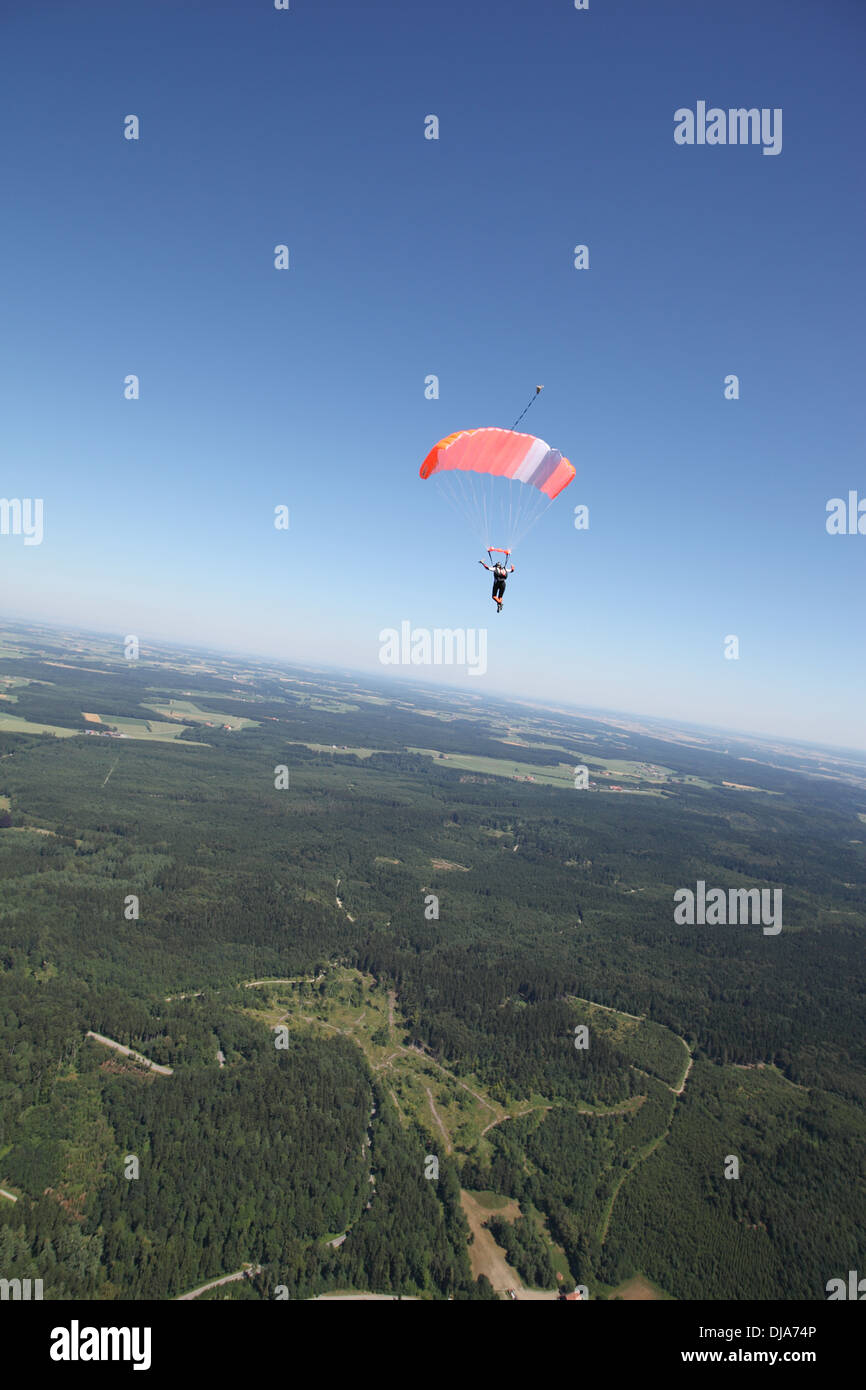 Skydiver under canopy is approaching the landing area. Hopefully she is ...