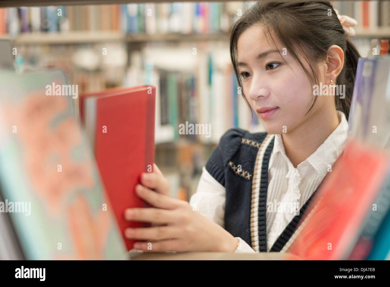 Student picking book from shelf hi-res stock photography and images - Alamy
