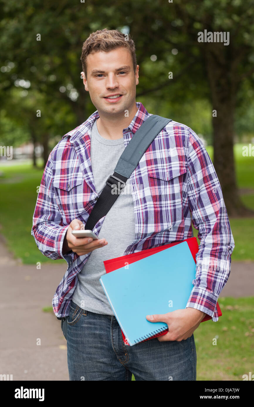 Handsome student standing texting hi-res stock photography and images ...