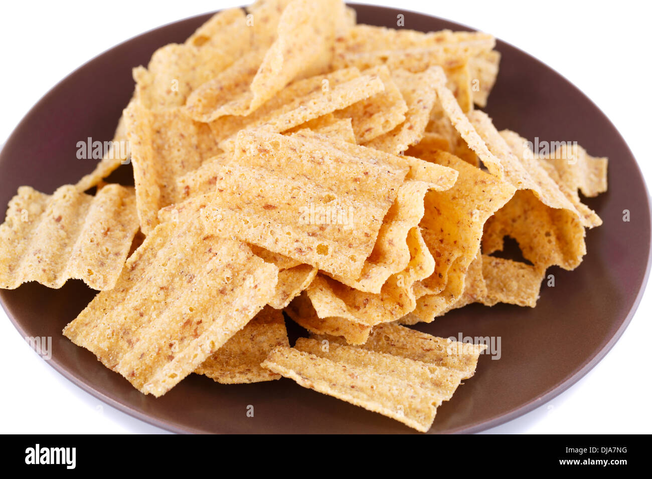 Wheat chips on plate isolated on white background Stock Photo - Alamy