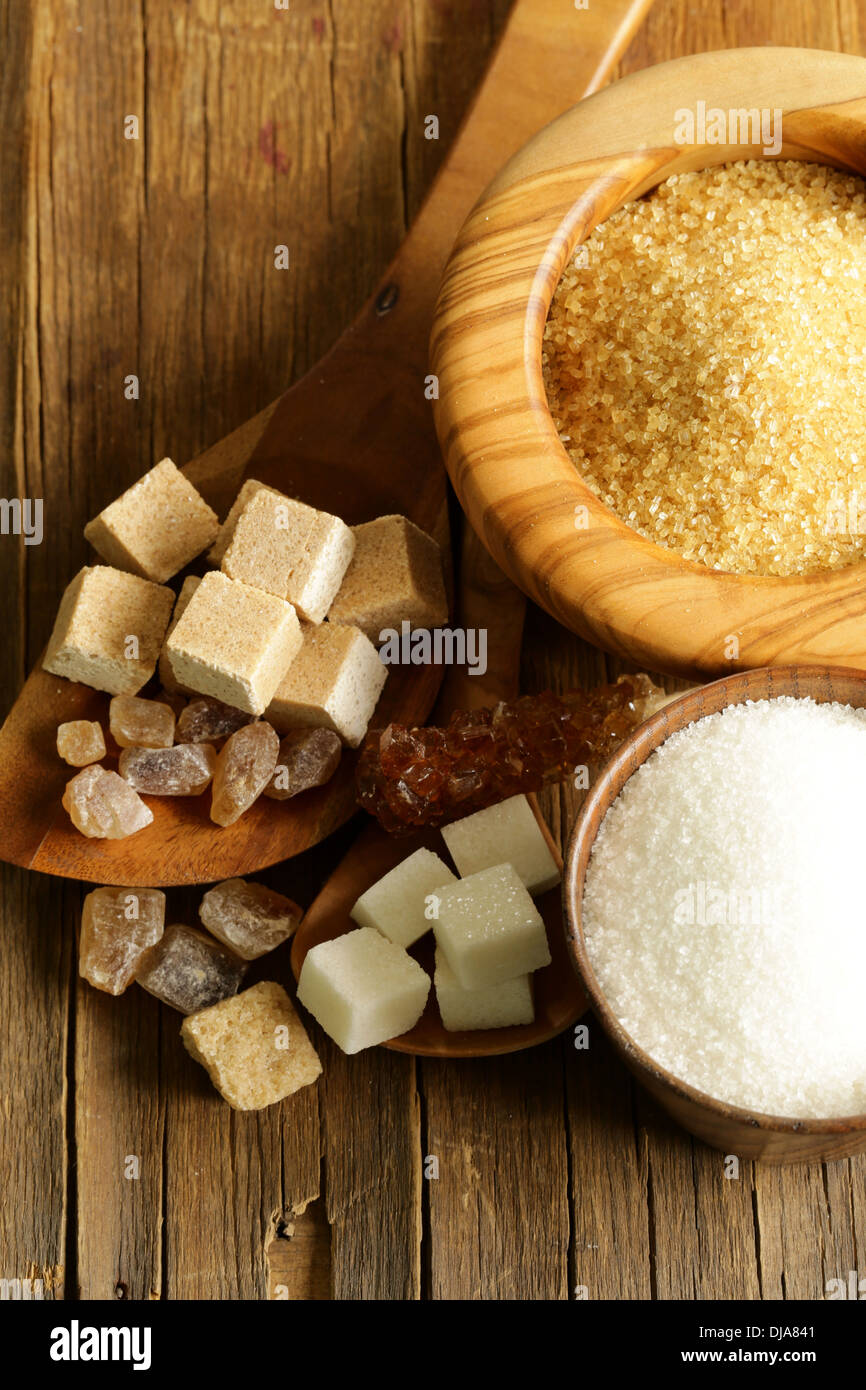 different kinds of sugar - brown, white, refined sugar on a wooden ...