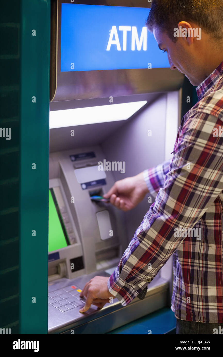 Brunette student withdrawing cash at an ATM Stock Photo - Alamy