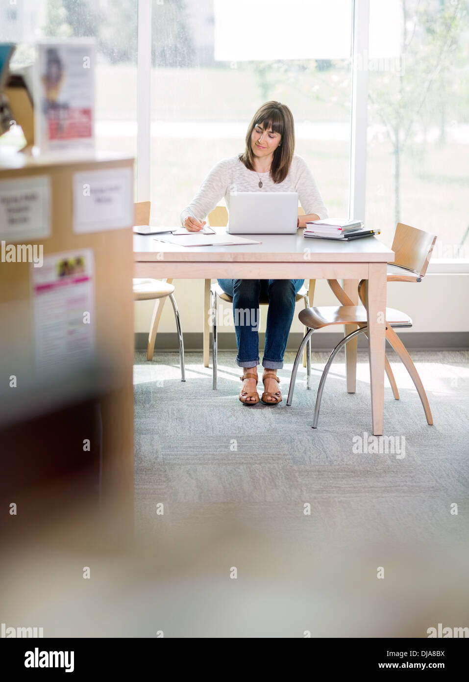 Student Writing Notes In Library Stock Photo - Alamy