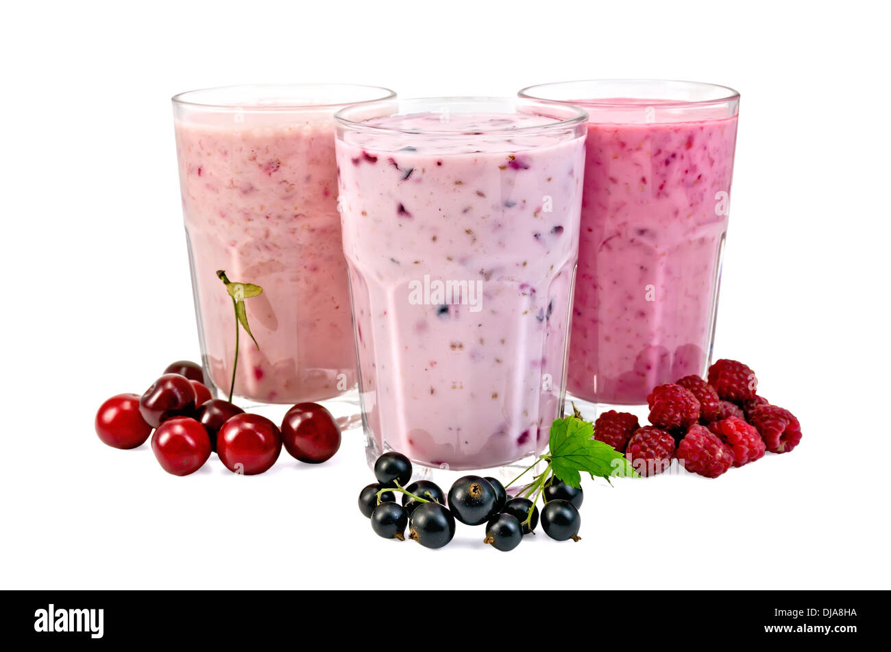 Milk shakes with berries of black currant, cherry, raspberry in glass ...