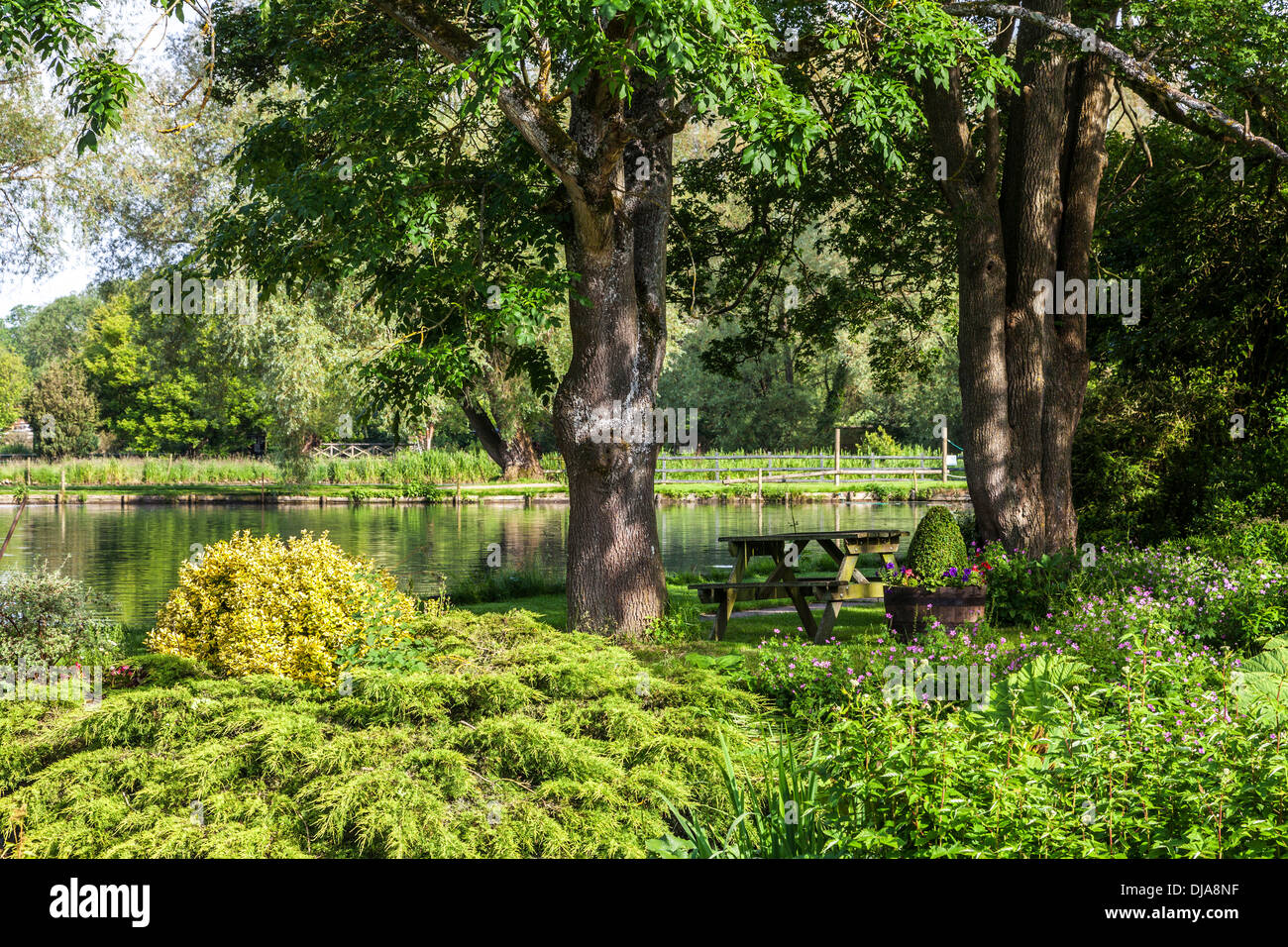 The pretty landscaped garden of the Trout Farm in the Cotswold village ...