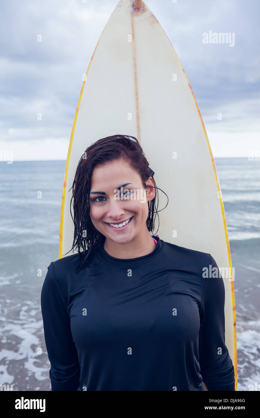Beautiful woman with surfboard at beach Stock Photo - Alamy