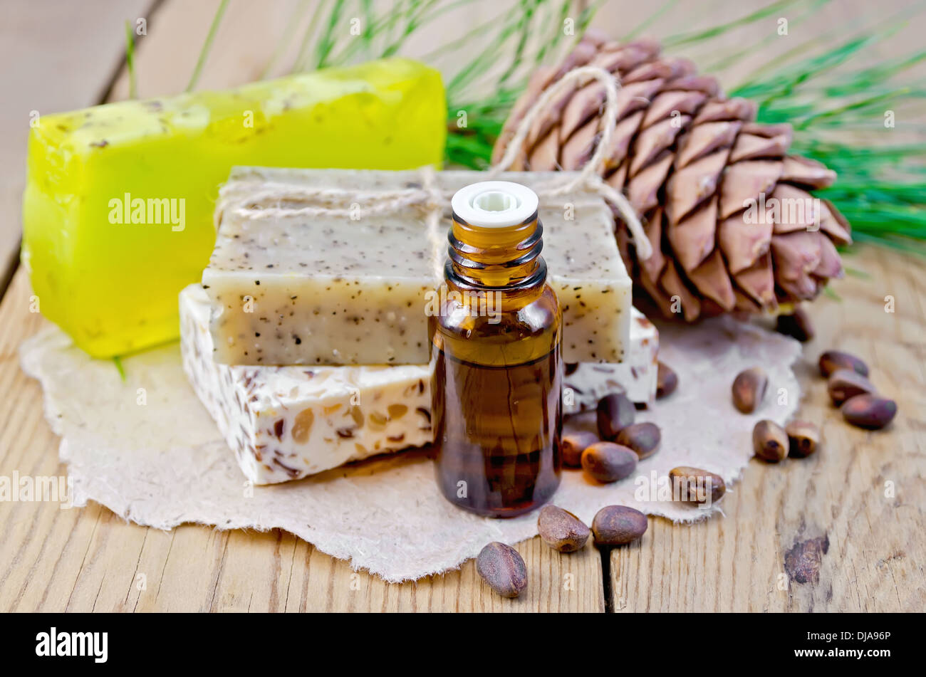 Cedar oil in a bottle, cedar cone, three homemade soap, cedar nuts on ...