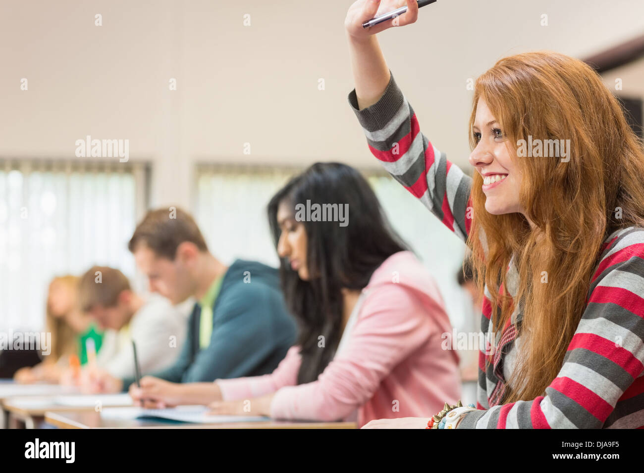 Female student raising hand hi-res stock photography and images - Alamy