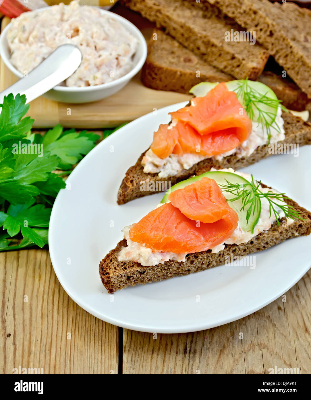 Sandwiches on two pieces of rye bread with cream, dill, cucumber and ...