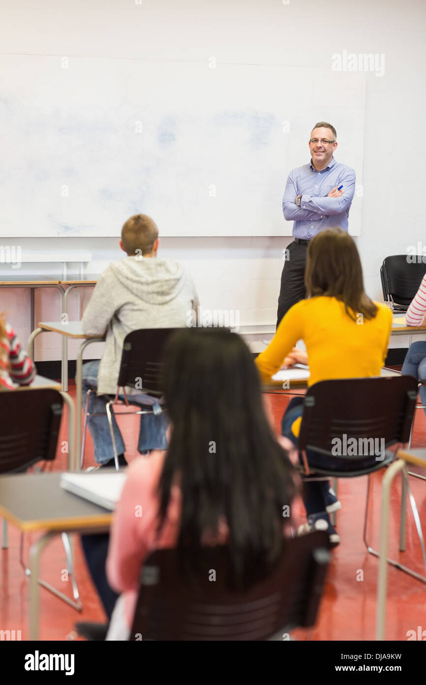 Attentive students with teacher in the classroom Stock Photo - Alamy