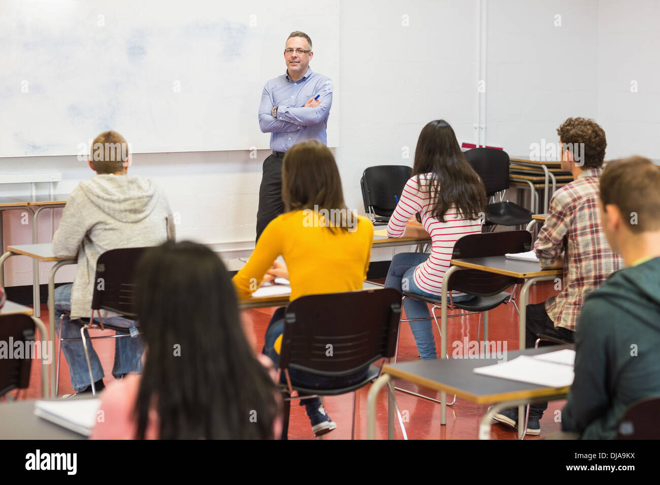 Attentive students with teacher in the classroom Stock Photo - Alamy