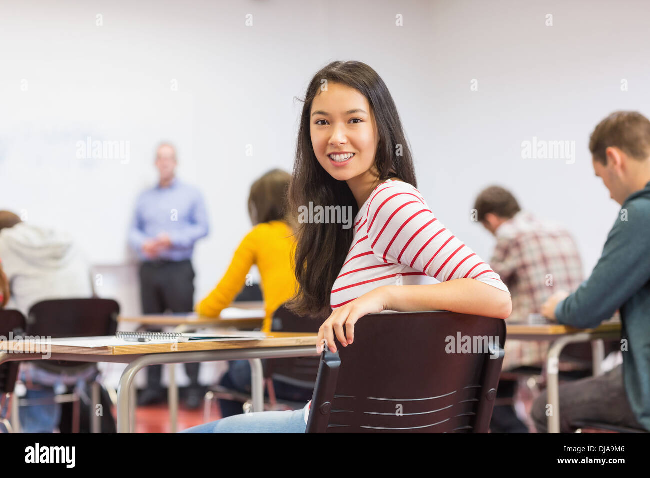 Female with blurred teachers students in classroom Stock Photo - Alamy