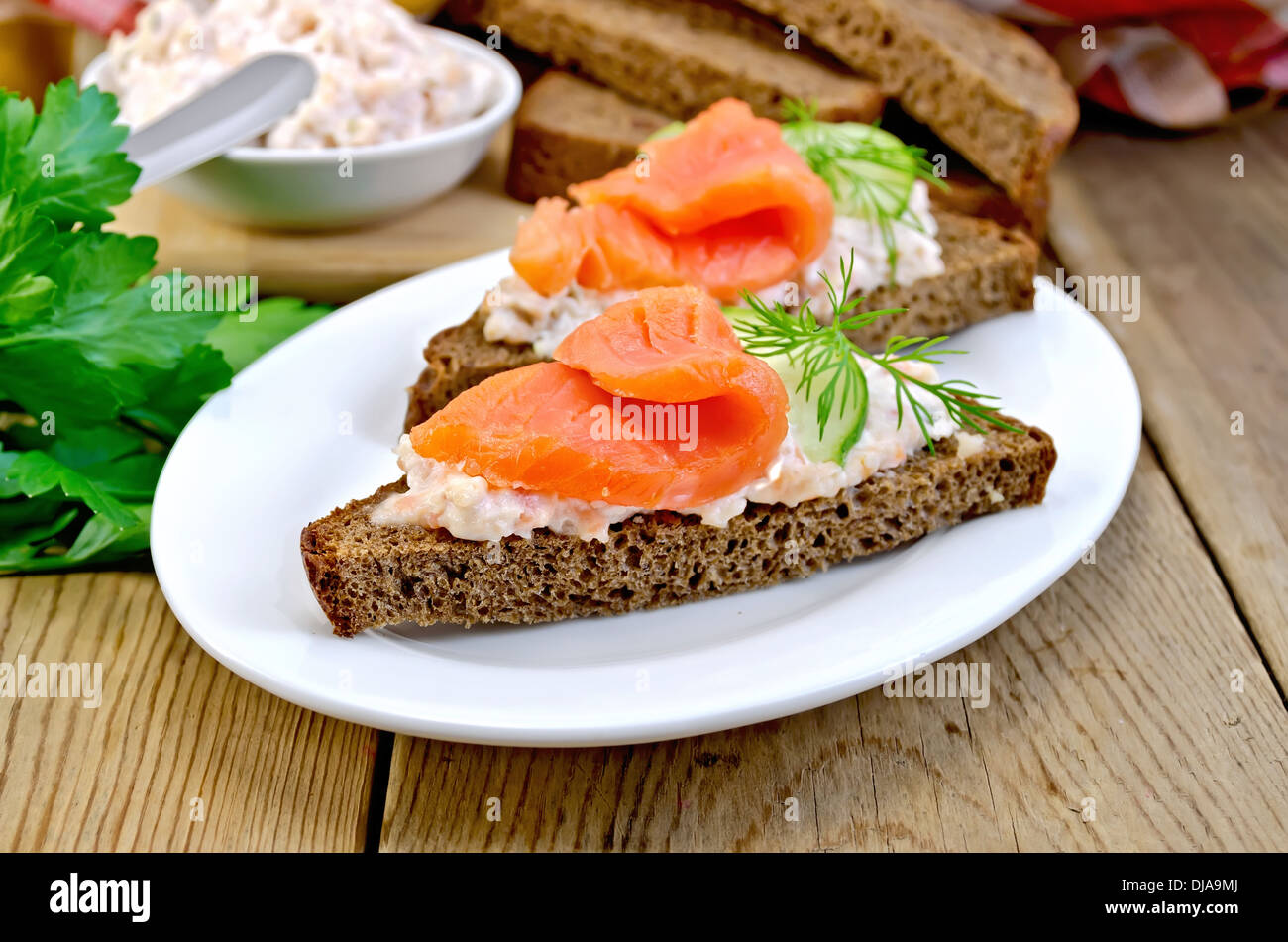 Sandwiches on two pieces of rye bread with cream, dill, cucumber and ...