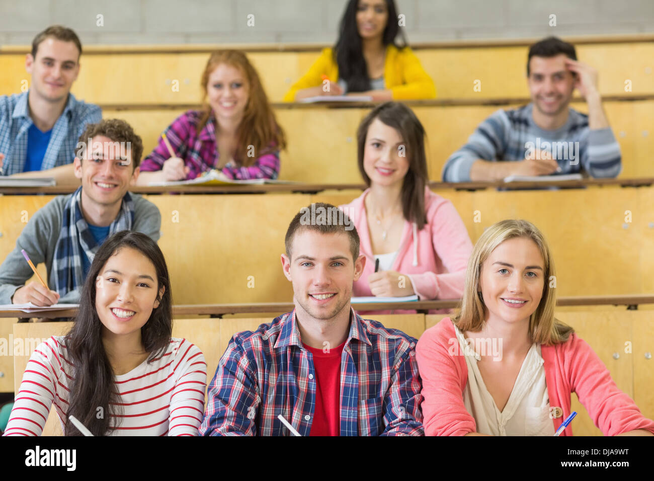 Smiling students sitting at the lecture hall Stock Photo - Alamy