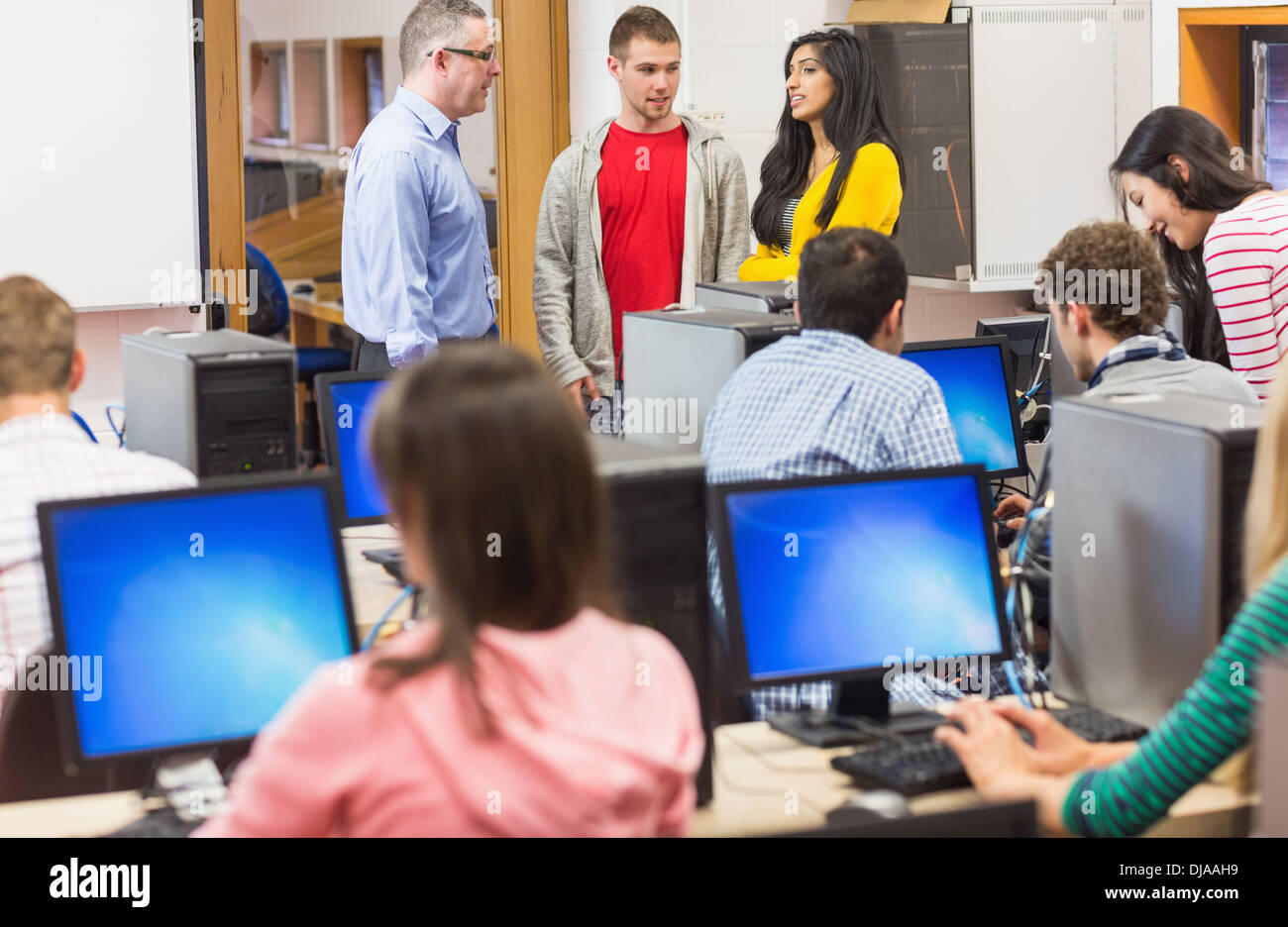 Teacher and students in the computer room Stock Photo - Alamy