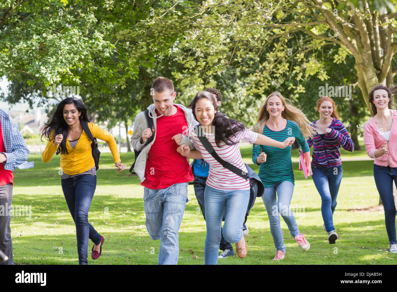 College students running in the park Stock Photo - Alamy