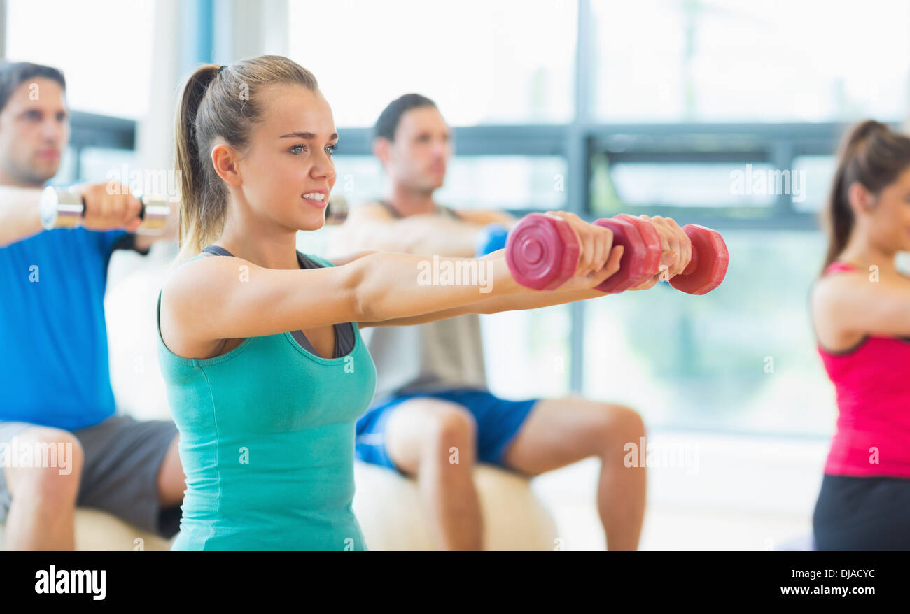 People lifting dumbbell weights in the gym Stock Photo - Alamy