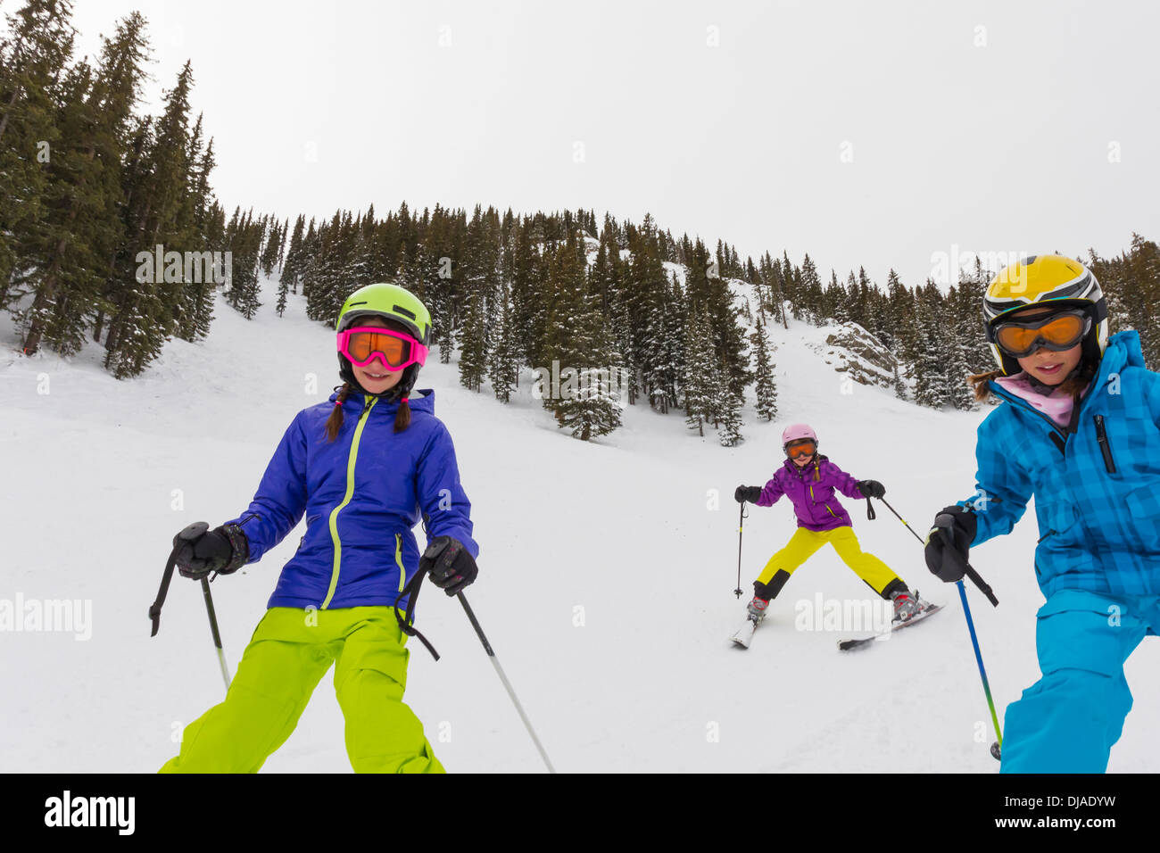 Girls skiing together on snowy slope Stock Photo - Alamy