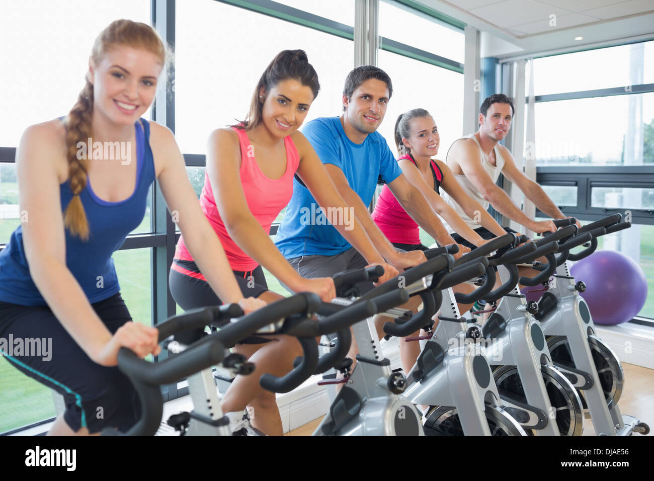 Five people working out at spinning class Stock Photo - Alamy