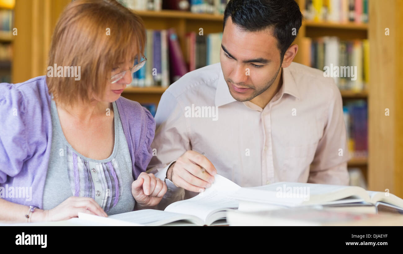 Adult students studying together in the library Stock Photo - Alamy