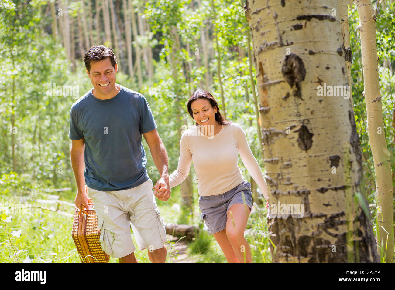 Couple walking together in forest Stock Photo - Alamy