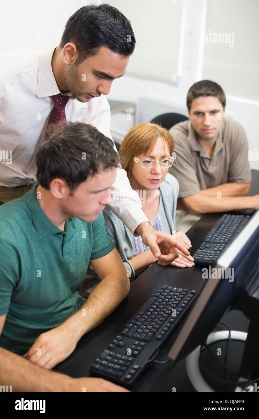 Female teacher presenting students in hi-res stock photography and ...