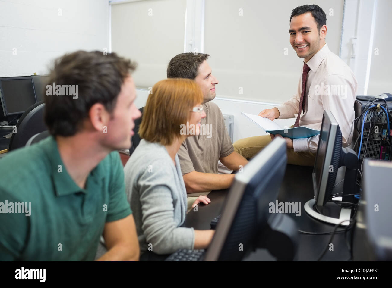 Teacher and mature students in computer room Stock Photo - Alamy