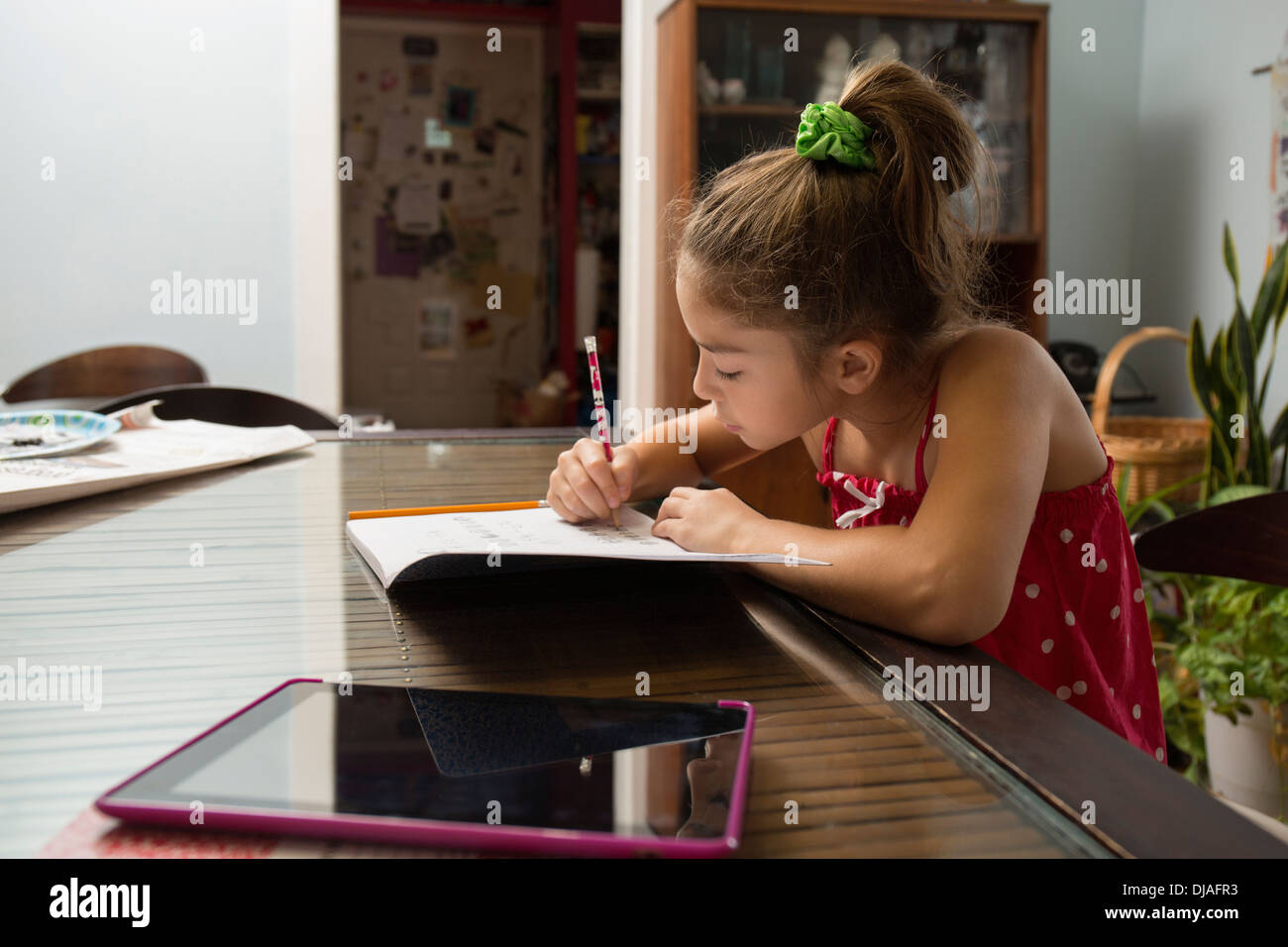 Mixed race girl doing homework Stock Photo - Alamy
