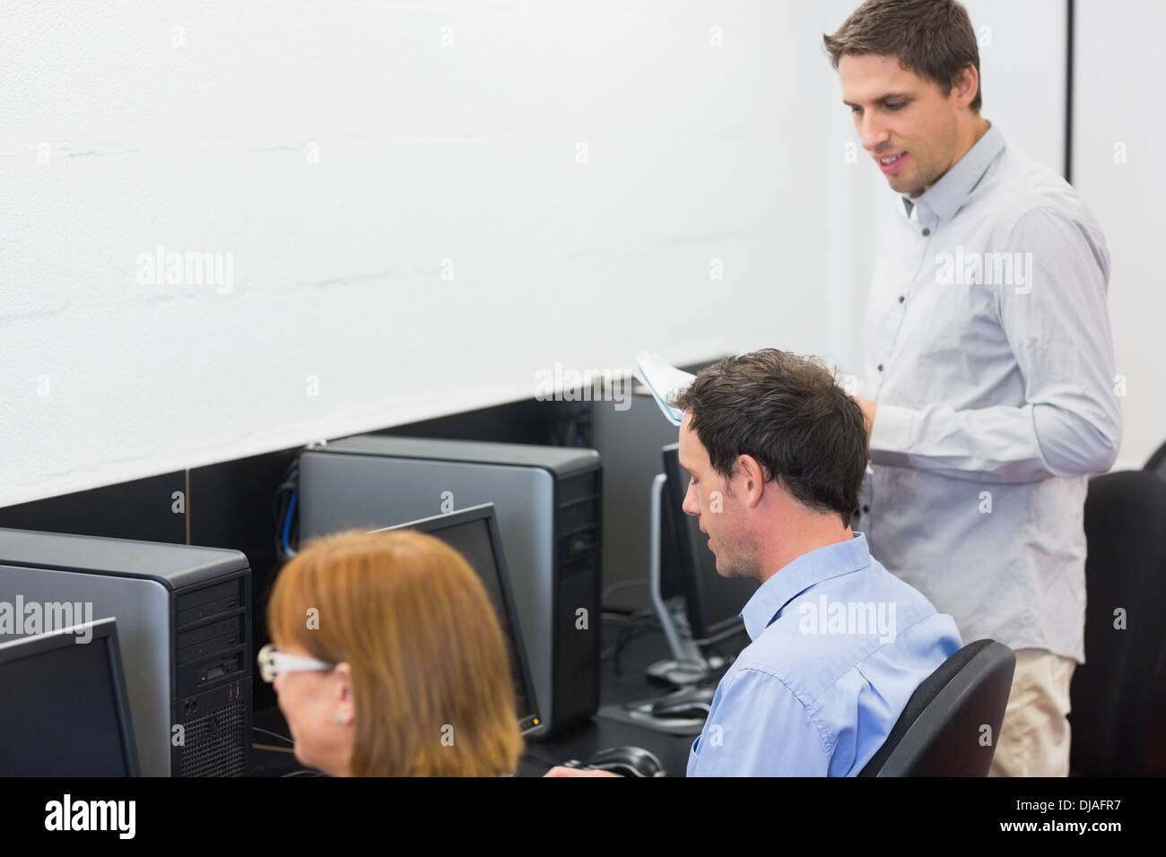 Teacher and mature students in computer room Stock Photo - Alamy