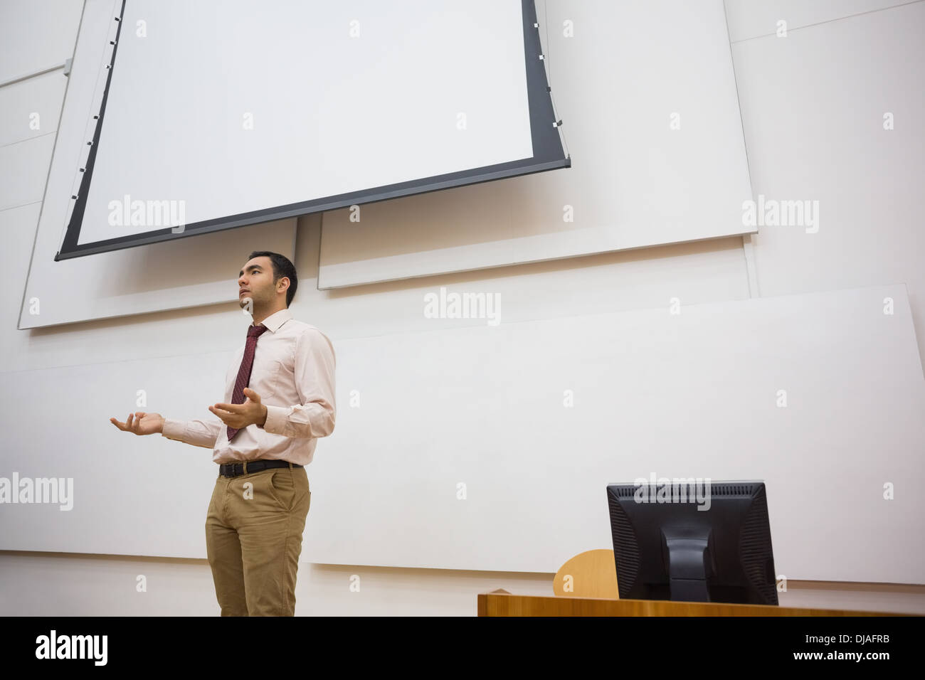 Teacher standing in the lecture hall Stock Photo - Alamy