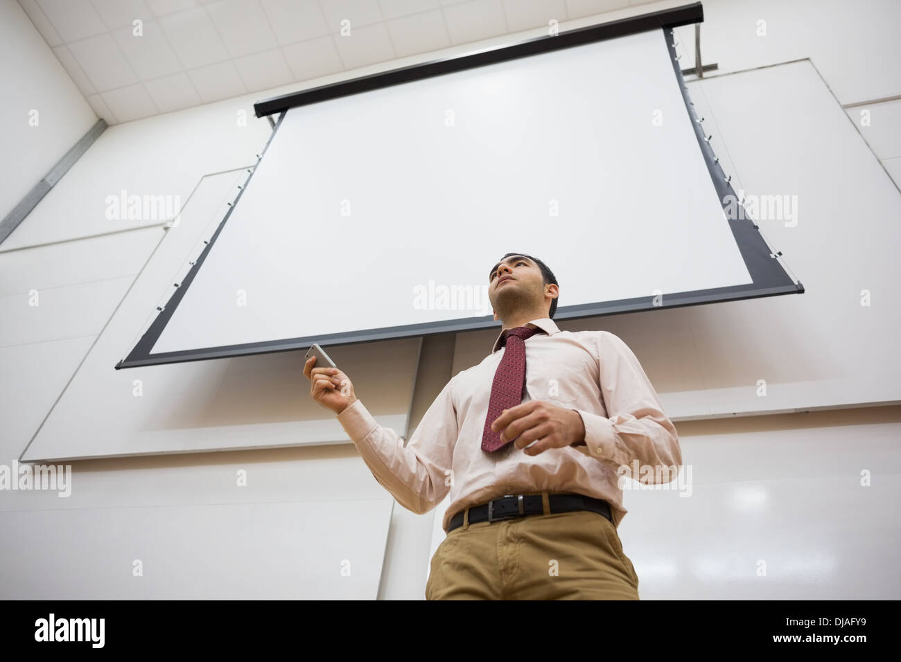 Teacher with projection screen in the lecture hall Stock Photo - Alamy