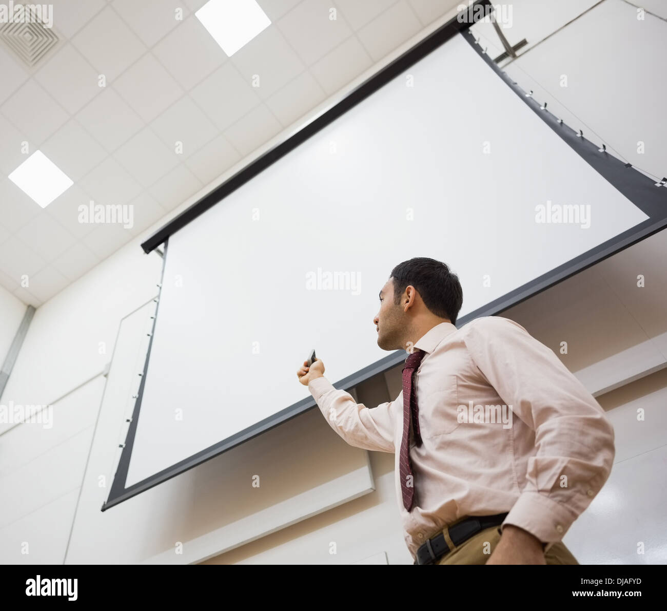 Male teacher with projection screen in the lecture hall Stock Photo - Alamy