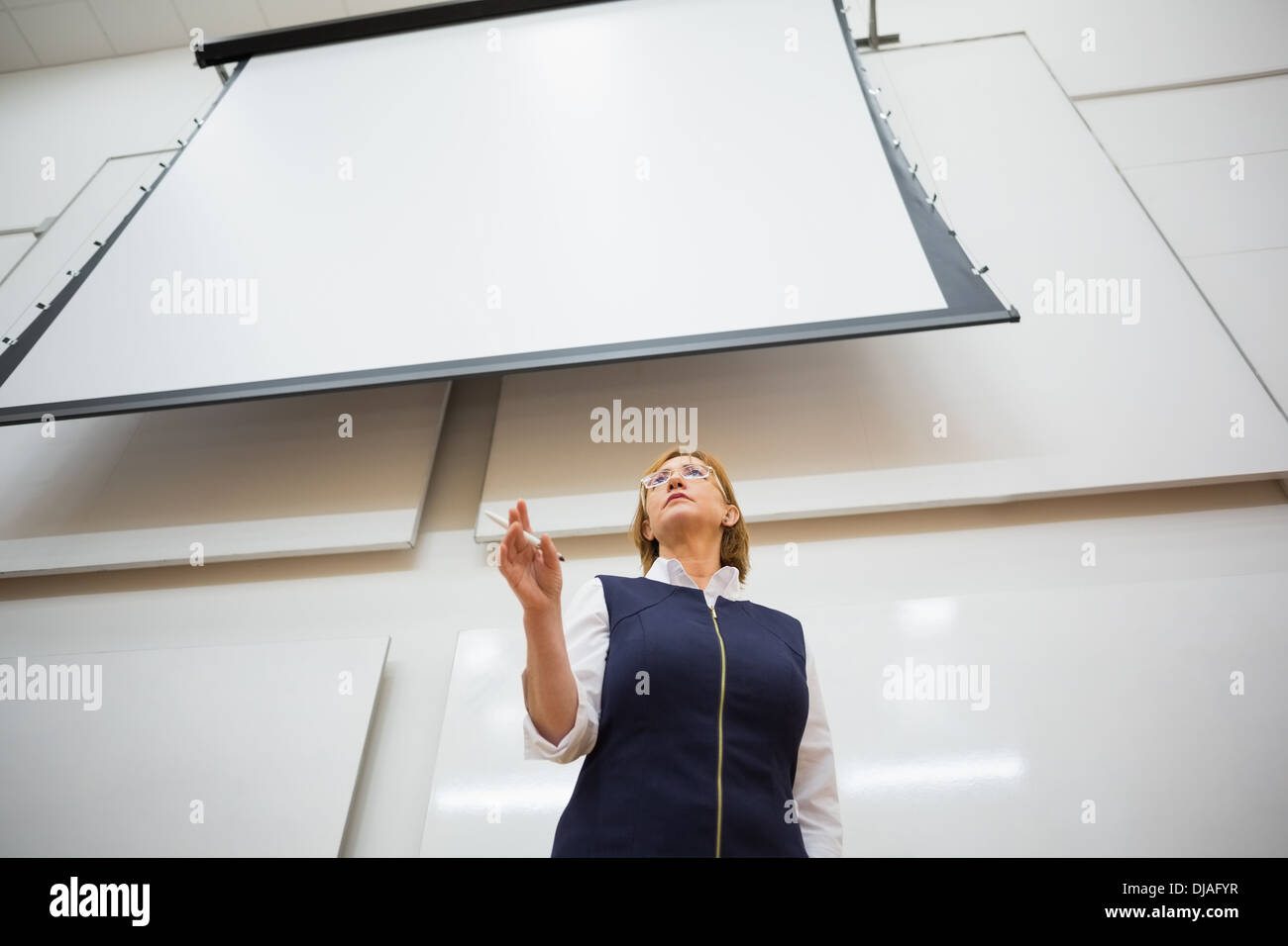 Elegant teacher with projection screen in the lecture hall Stock Photo ...