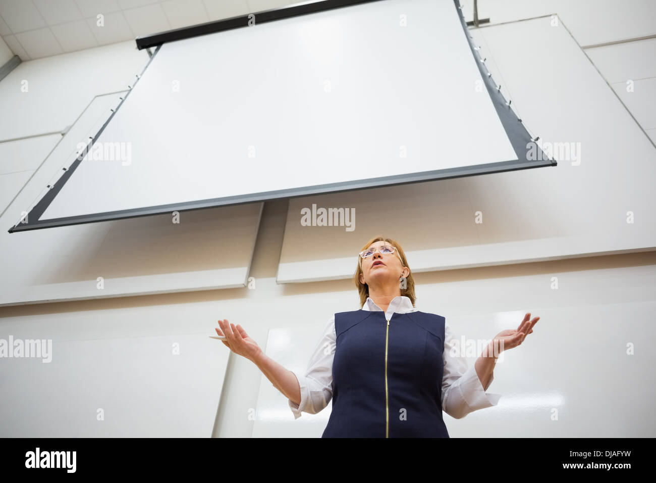 Female teacher with projection screen in the lecture hall Stock Photo ...