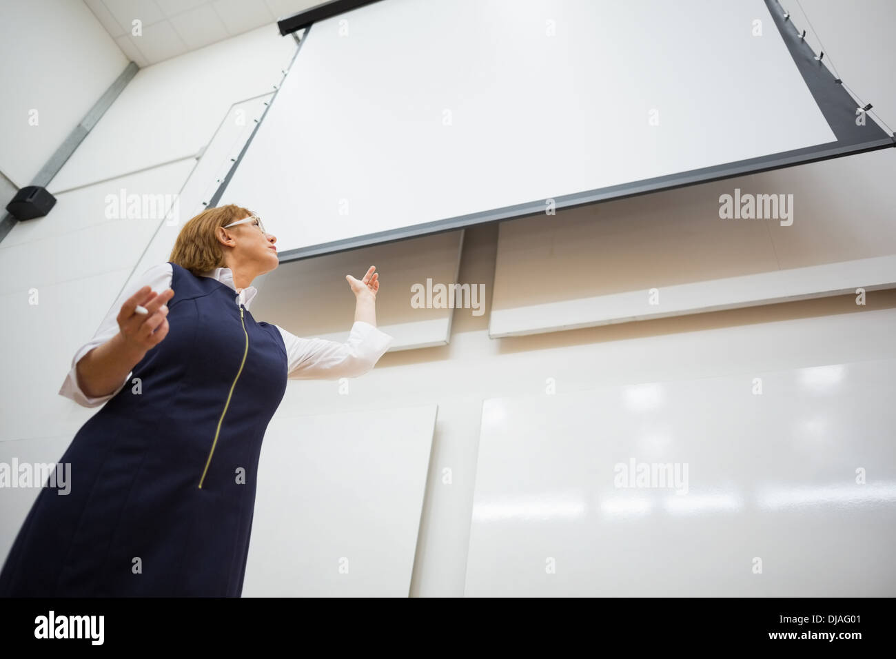 Female teacher with projection screen in the lecture hall Stock Photo ...
