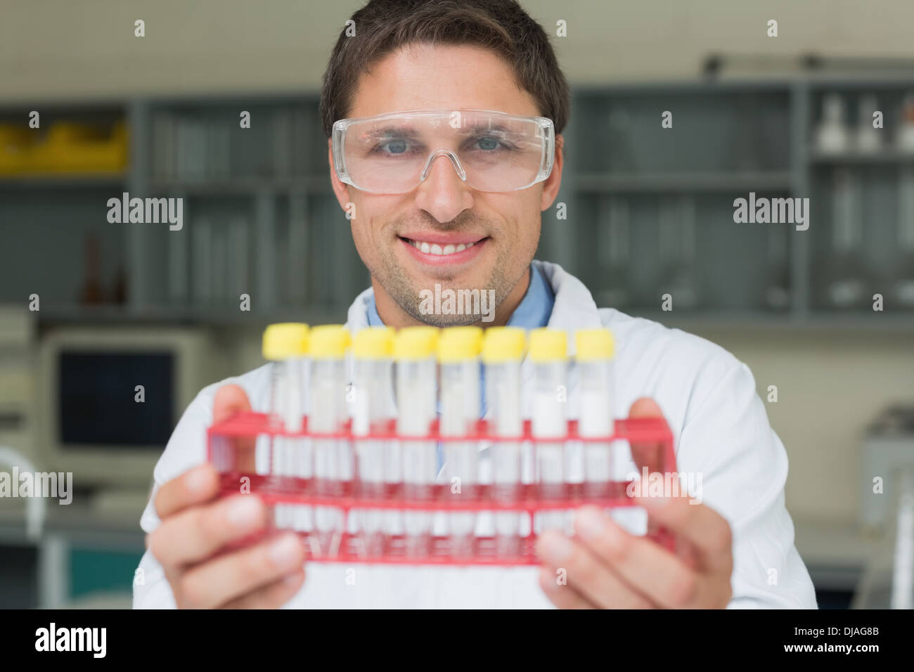Smiling male researcher with test tubes in the lab Stock Photo - Alamy