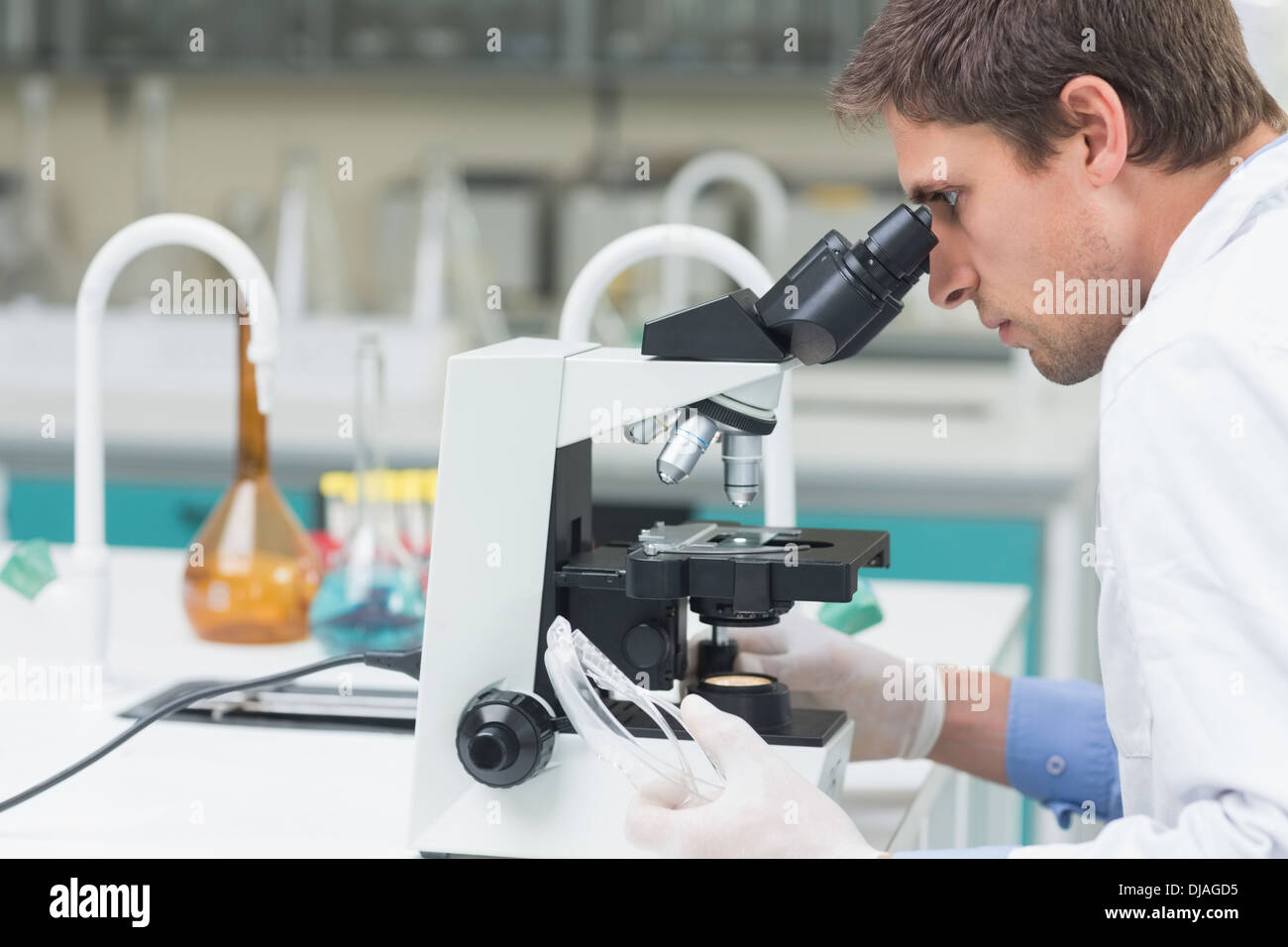 Scientific researcher using microscope in the laboratory Stock Photo ...